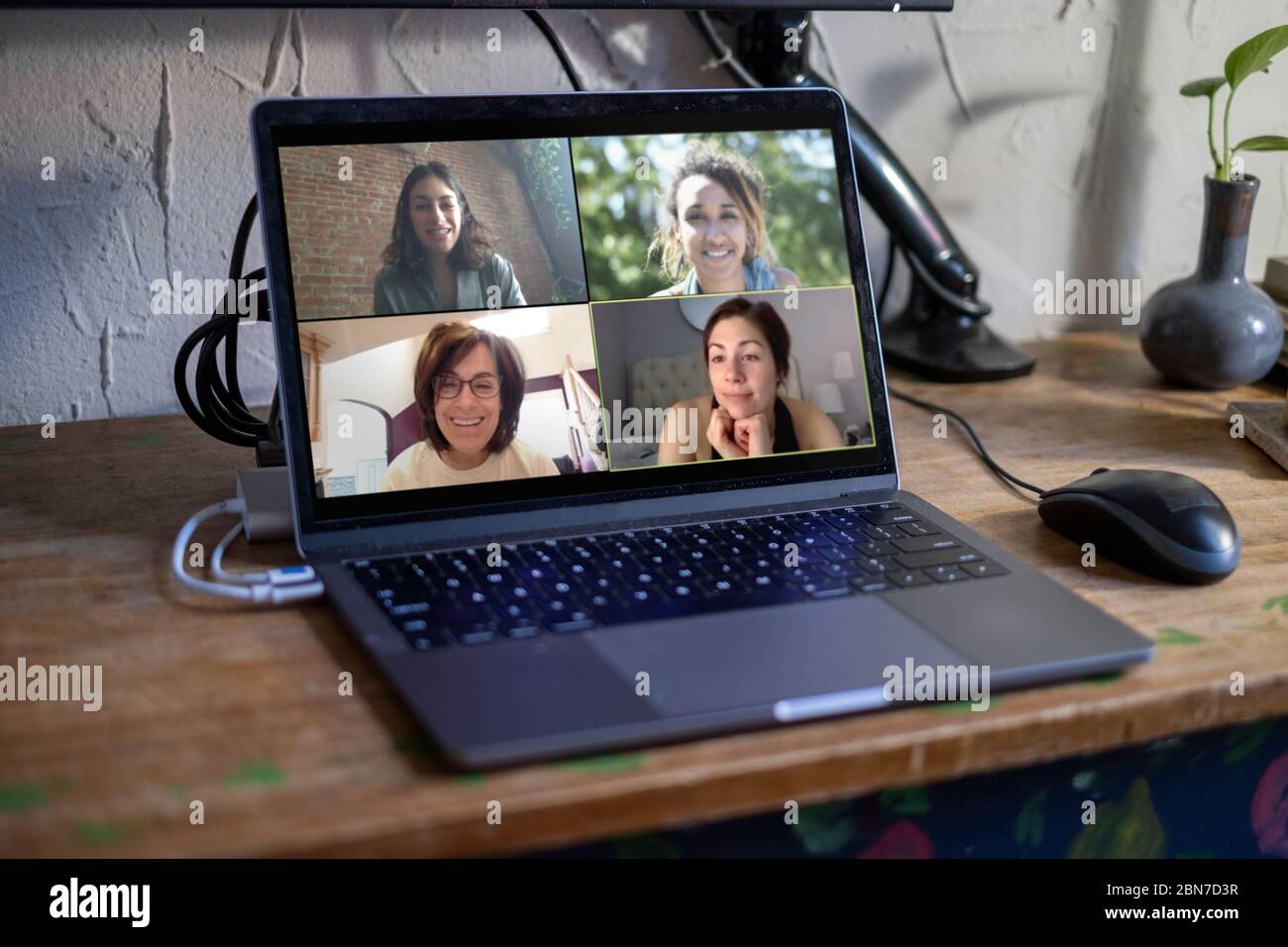 People having a virtual call online. Laptop on desk at home. Friends ...