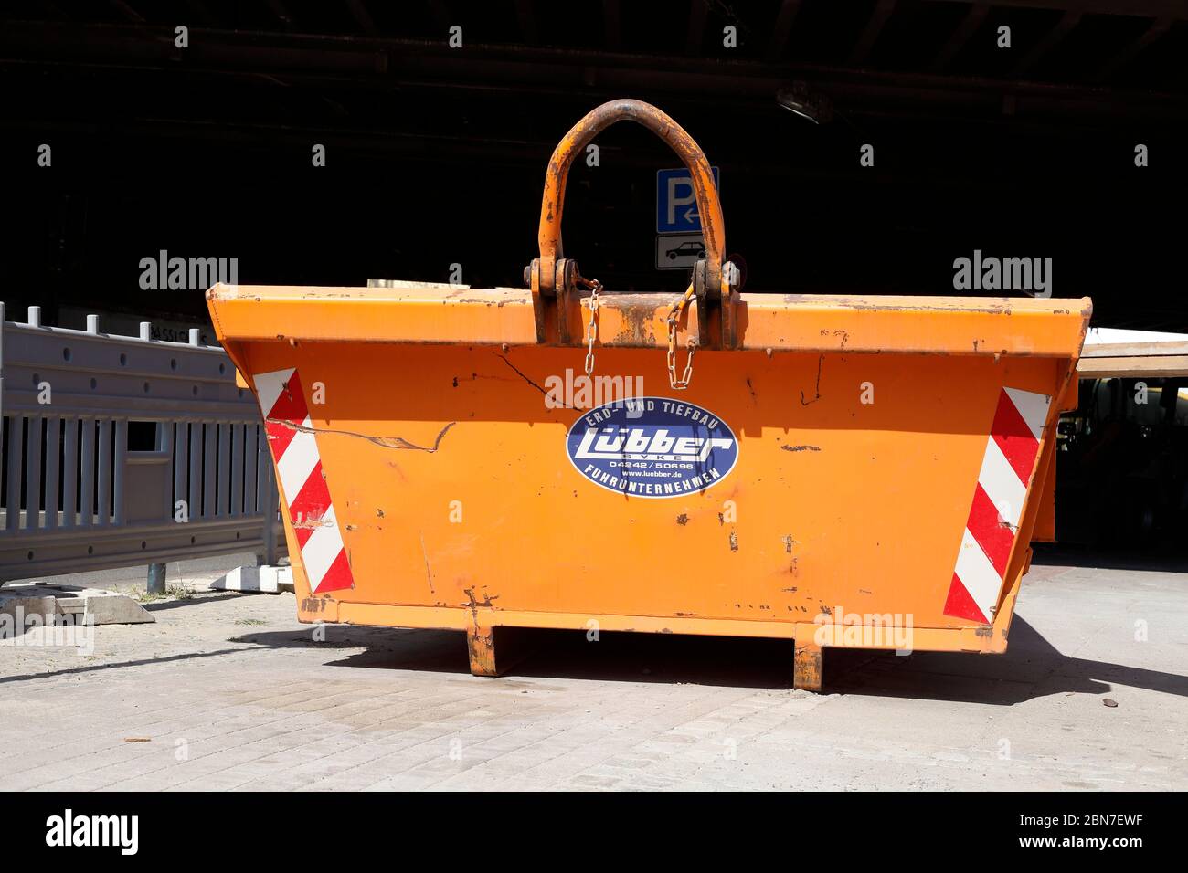 Orange skip for building rubble standing on a construction site ...