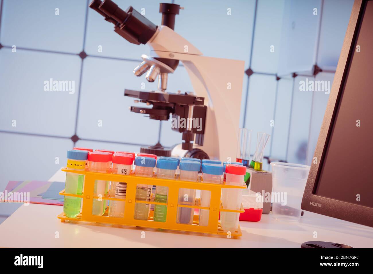 Scientific experiment in microbiological lab. Microscope and test tube ...