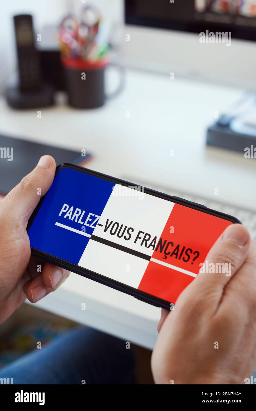 closeup of a young caucasian man, sitting at a desk, having his ...