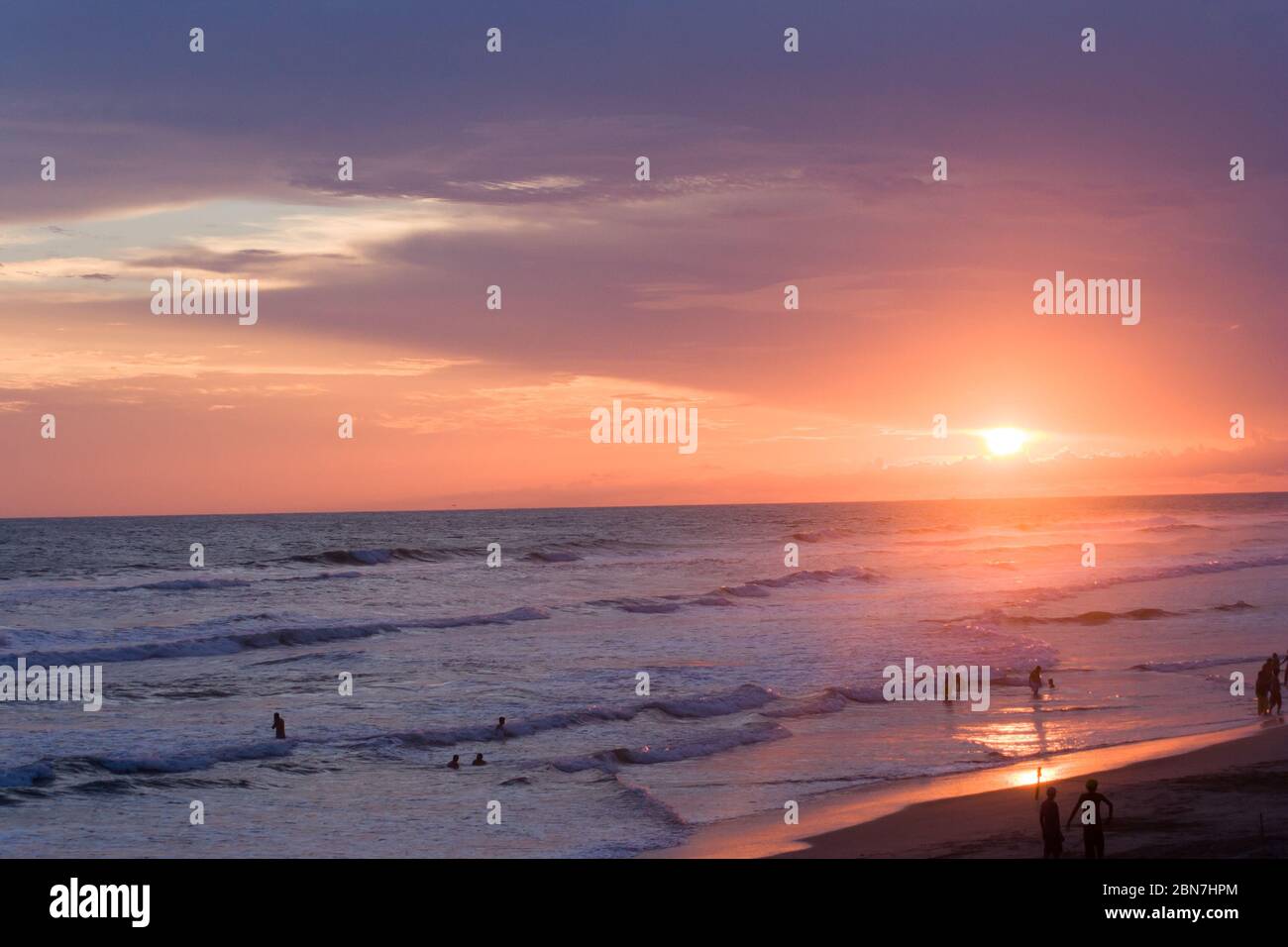 Sunset at Mexican Beach with People in the Sea Stock Photo - Alamy