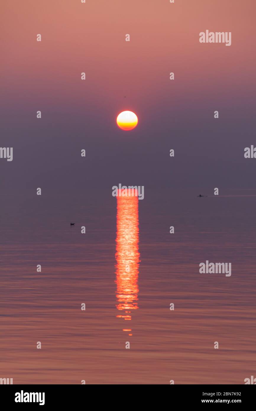 Crimson sunset over the sea hi-res stock photography and images - Alamy