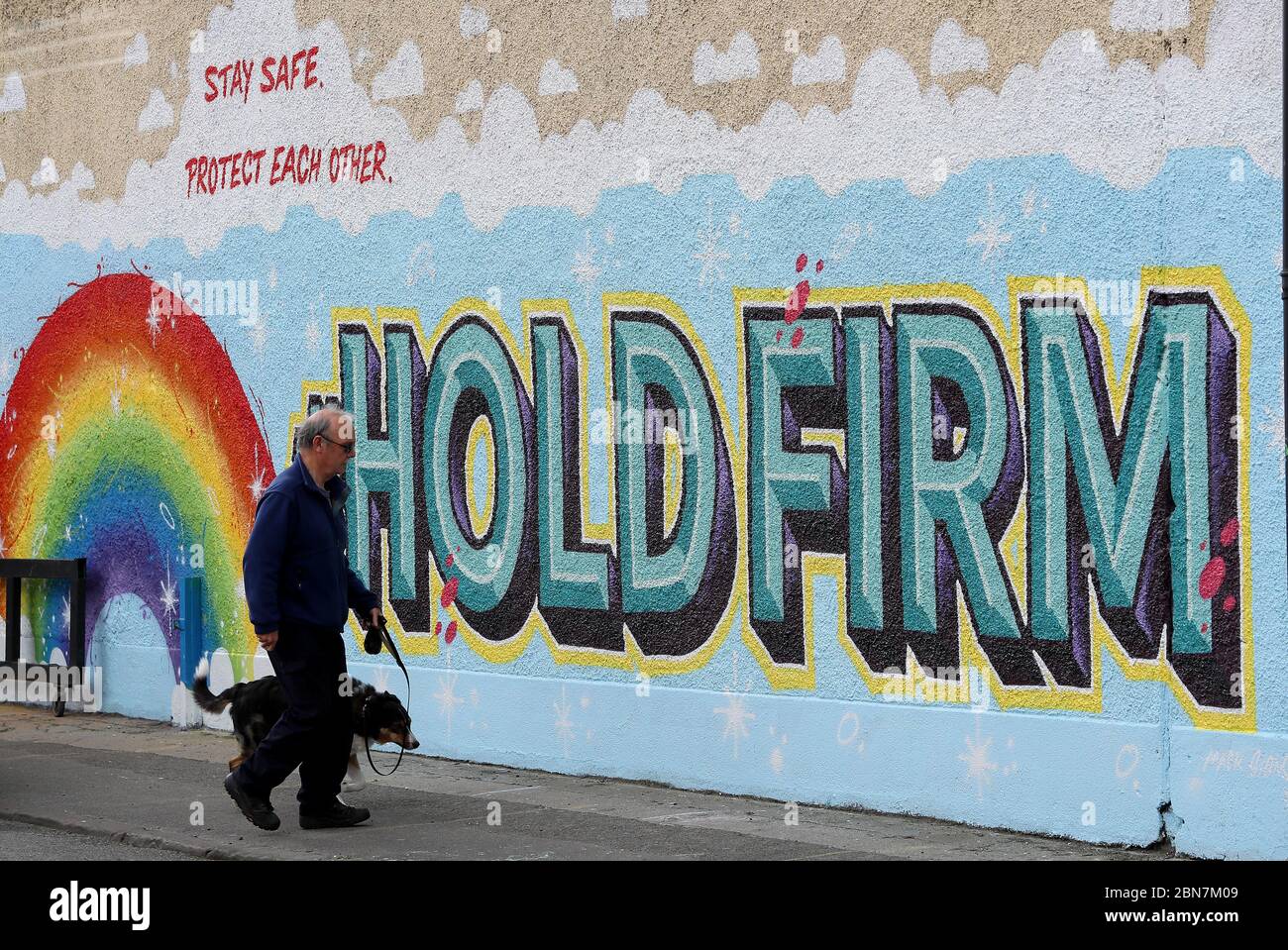 A man walks his dog past a new mural in Dublin's city centre inspired ...