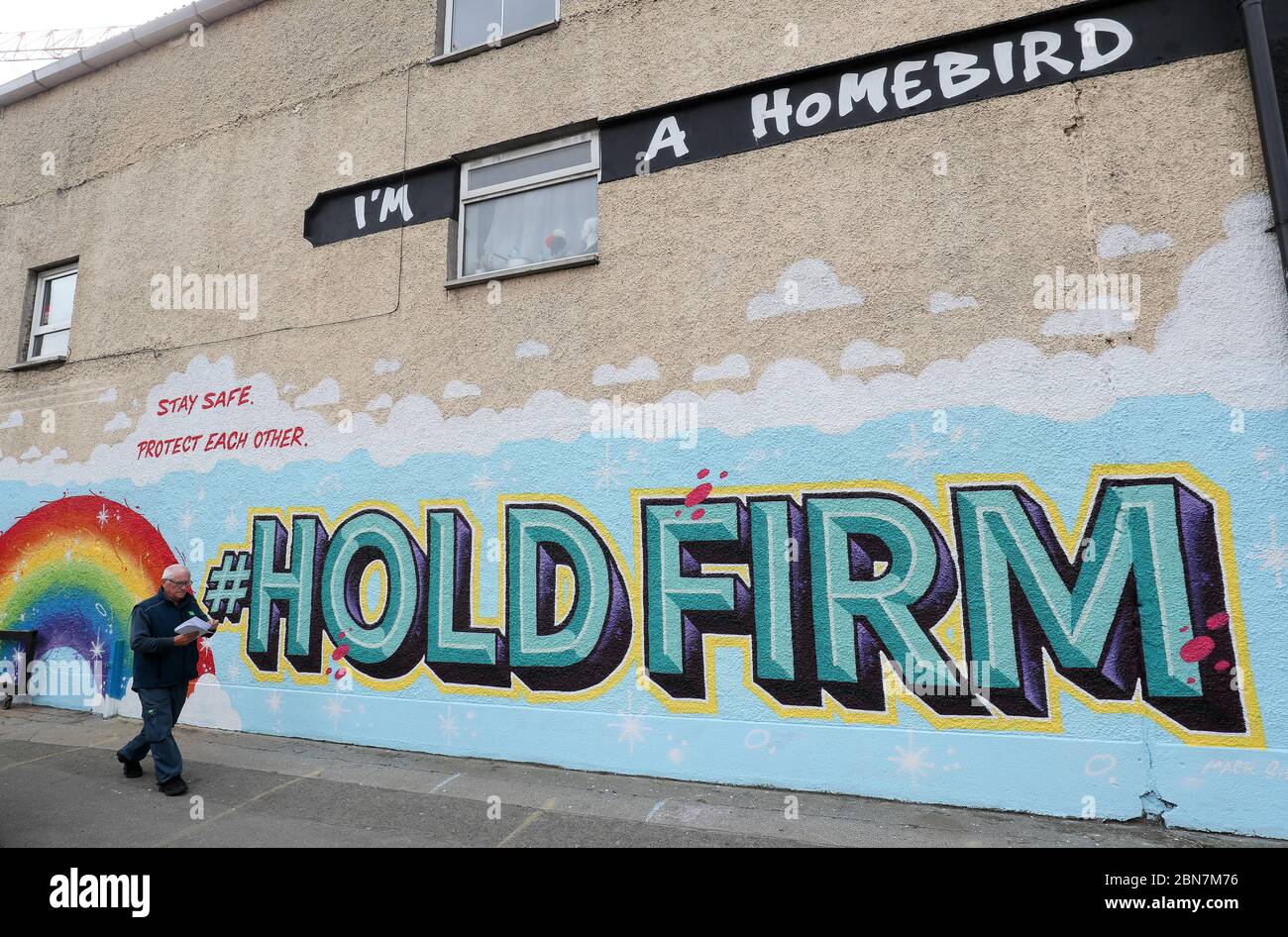 A post man walks past a new mural in Dublin's city centre inspired by ...