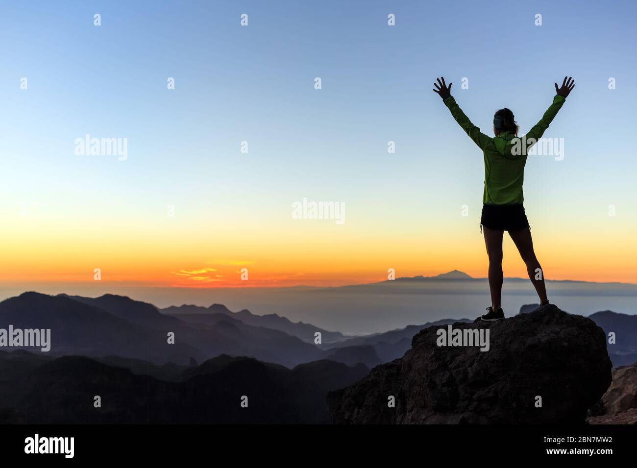 Woman successful hiking or climbing in mountains, motivation and ...