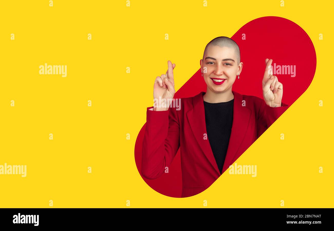 Portrait of young woman with freaky look on bright bicolor background ...
