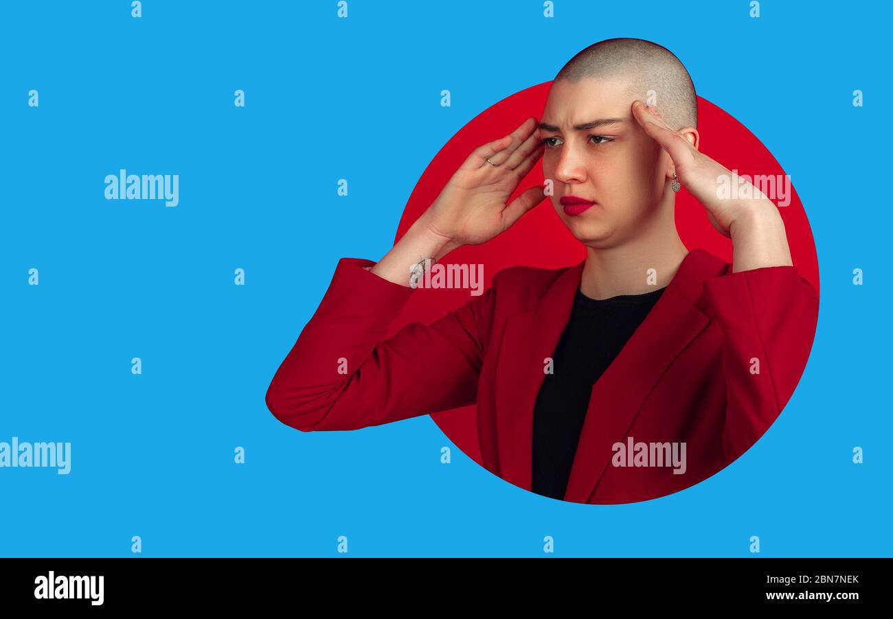 Portrait of young woman with freaky look on bright bicolor background ...