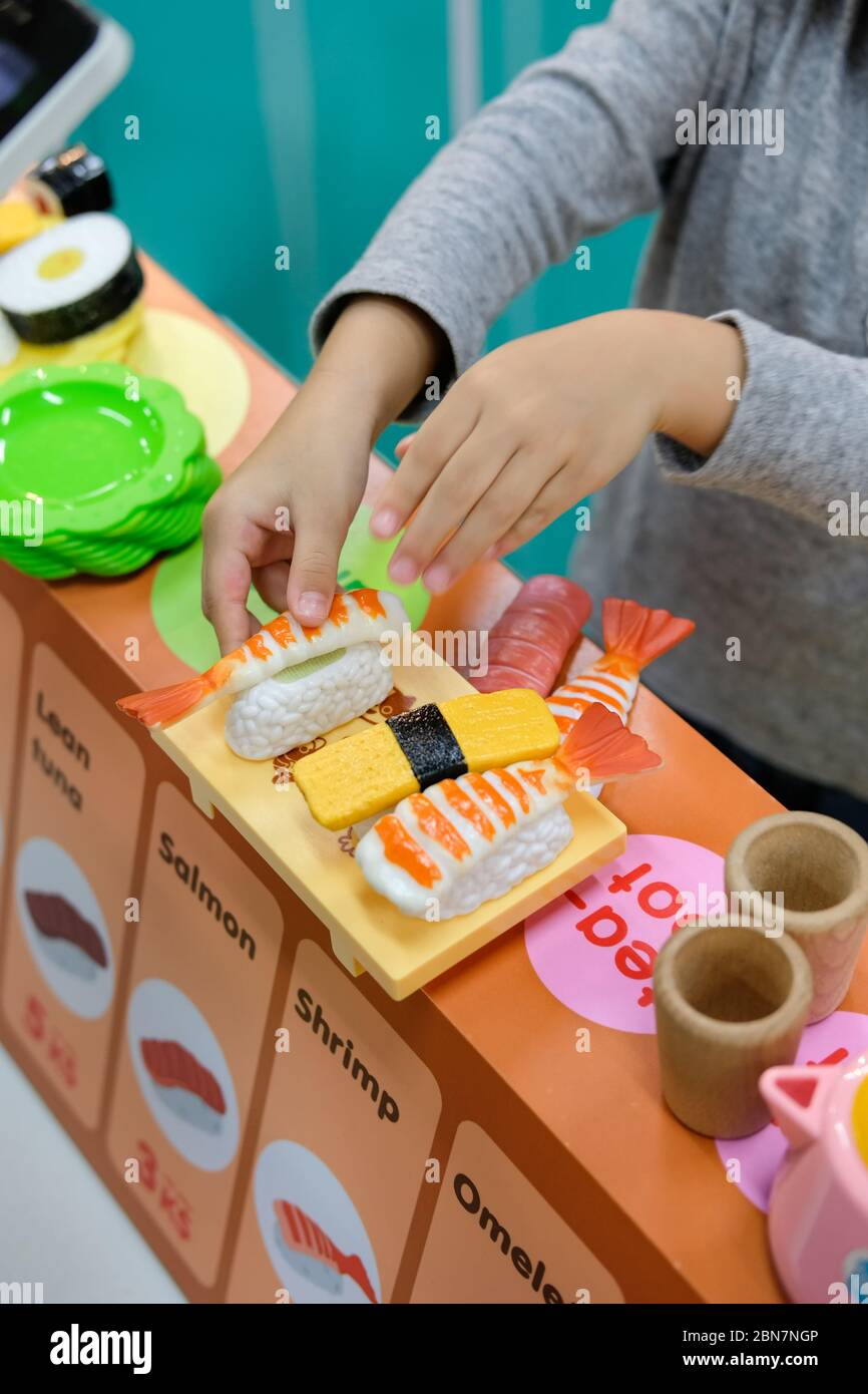 Child, kid role playing Toy Sushi chef in toy sushi bar at indoor ...