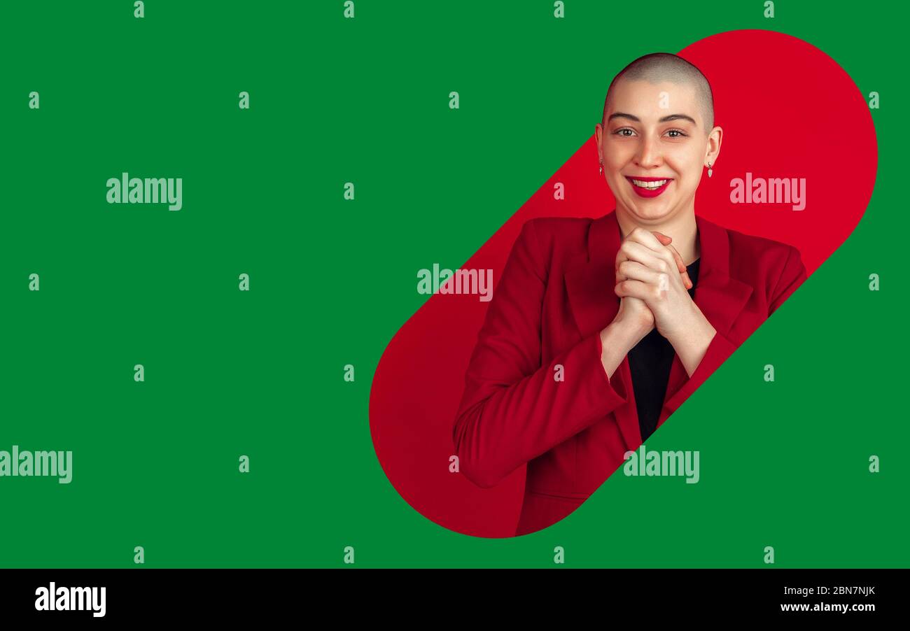 Portrait of young woman with freaky look on bright bicolor background ...