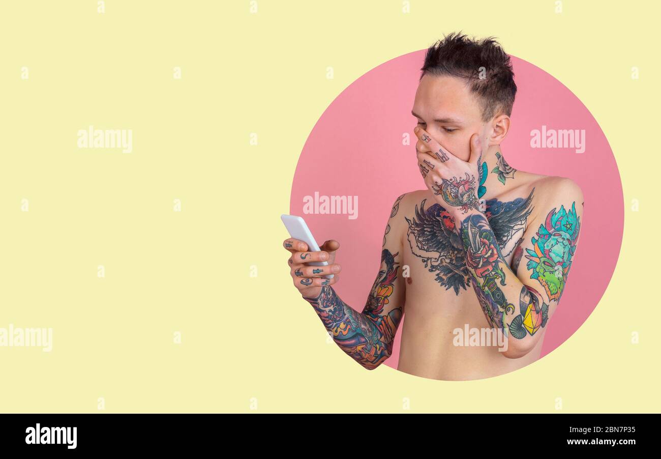 Portrait of young man on bright bicolor background. Unusual freaky look ...