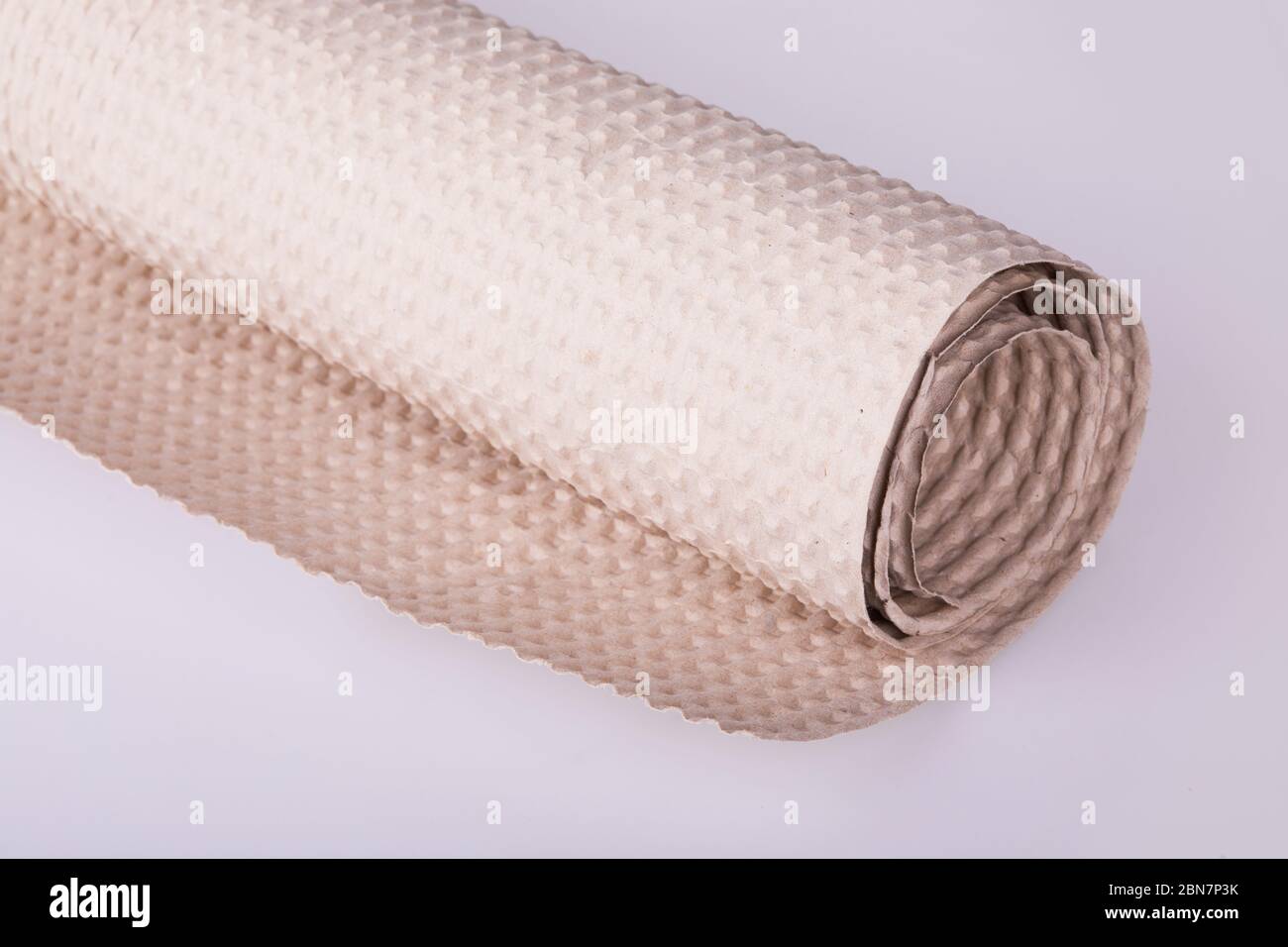 Roll of beige wrapping paper on a white background. It is used to ...
