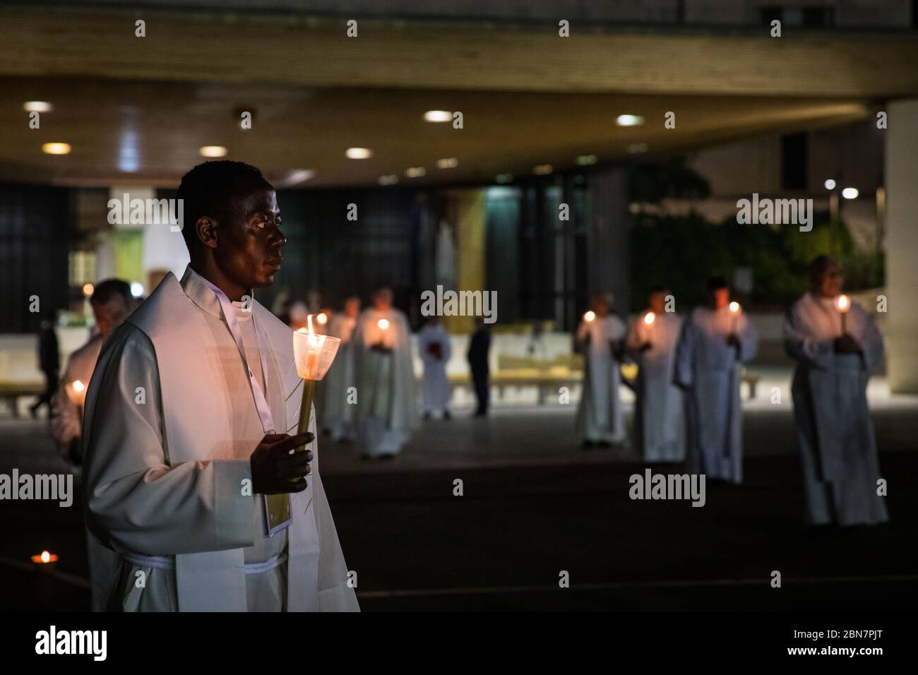 A priest takes part during the candle procession.Prayers of the rosary ...