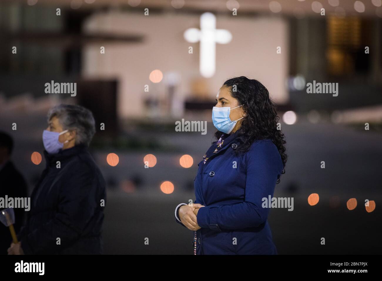 Women wearing face masks during the mass at the Apparition Chapel ...