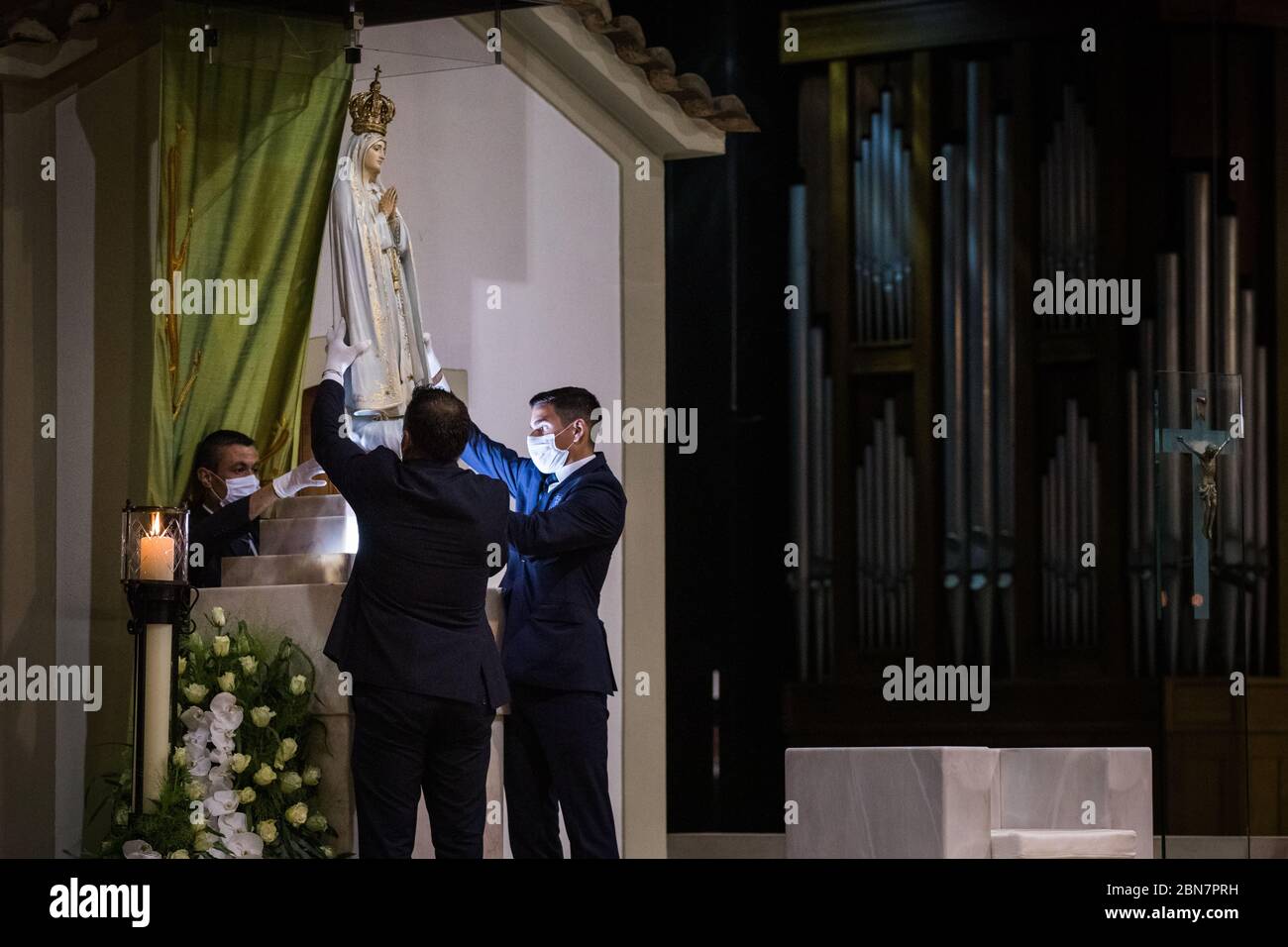 Men keep the Image of Our Lady of Fatima at the Chapel of Apparitions ...