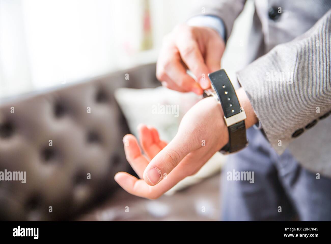 Man with a Suit Adjusting and Putting his Watch on his Wrist Stock ...