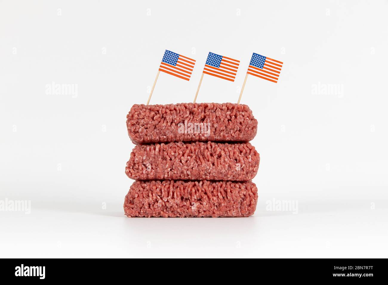 Pile of raw minced meat with three usa flags in it Stock Photo - Alamy