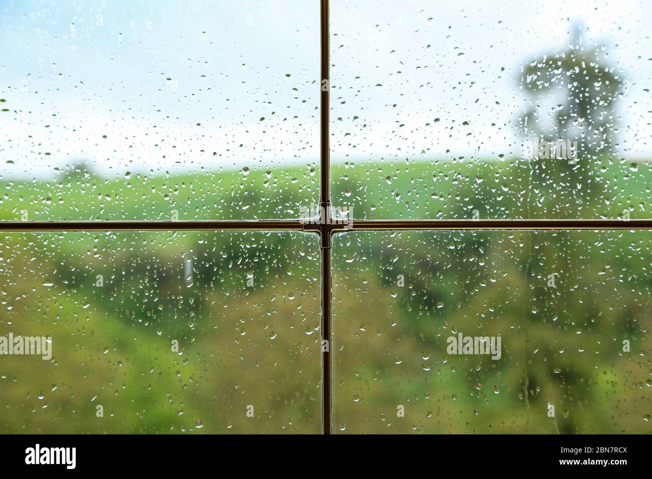 Rainy weather behind wet glass of a house window Stock Photo - Alamy