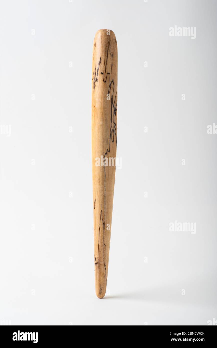 A narrow, handmade spirtle in spalted maple, photographed against a ...