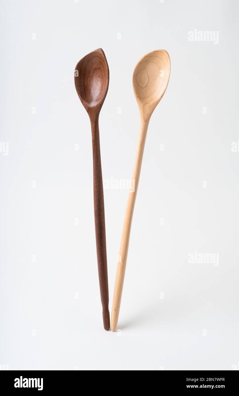 Two long, handmade spoons, one from walnut wood and the other from ...