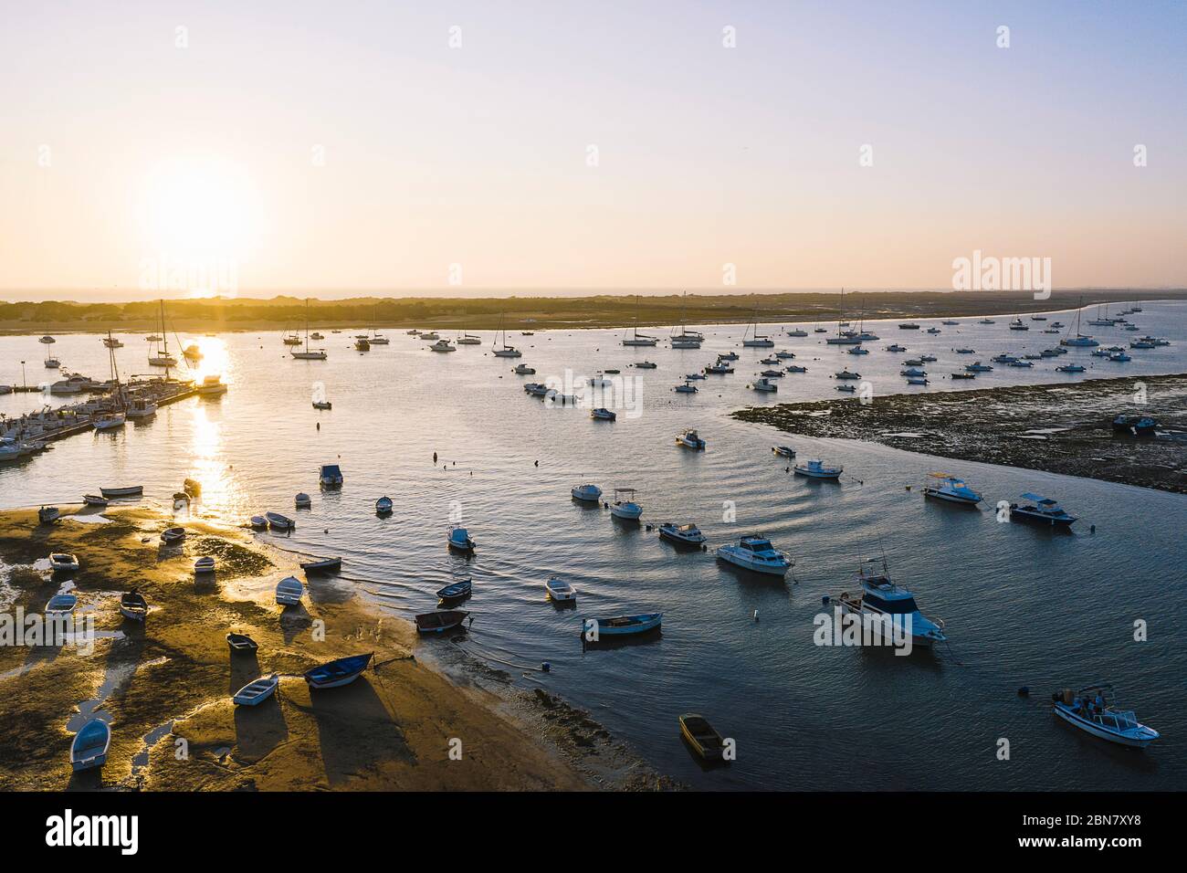 aerial view of a fishing port at sunset during low tide, marine ...