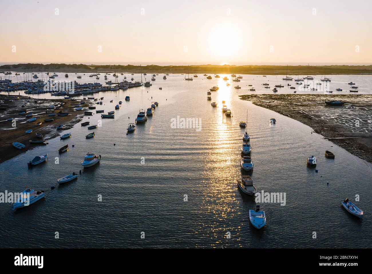 aerial view of a fishing port at sunset during low tide, marine ...
