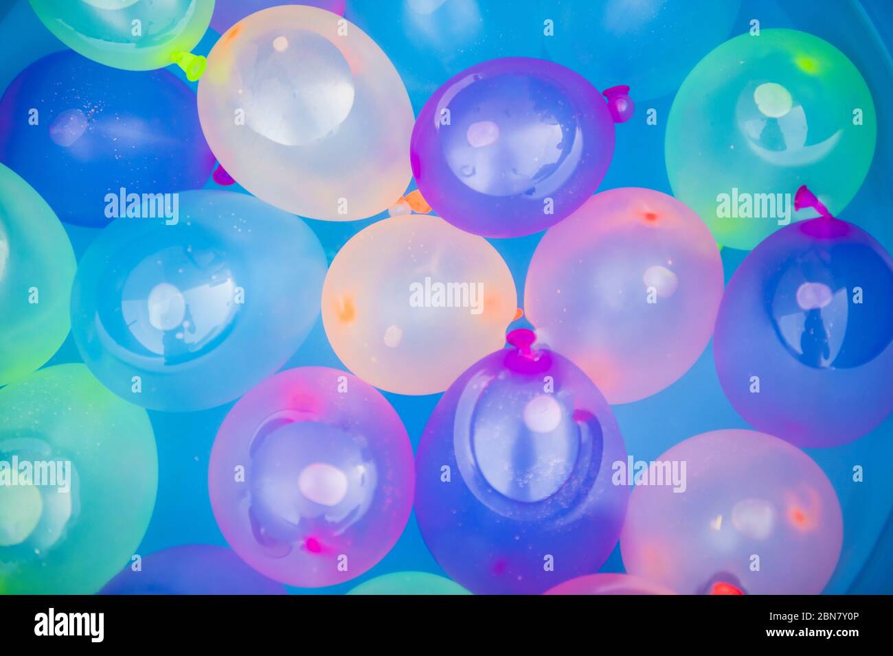 background of colored balloons floating in water Stock Photo - Alamy