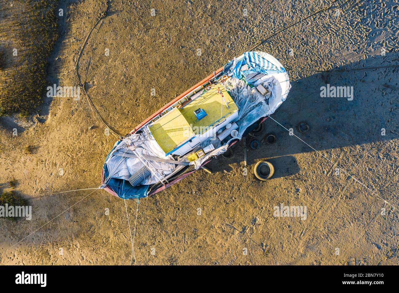 top view of an old fishing ship at low tide on the ground, marine ...
