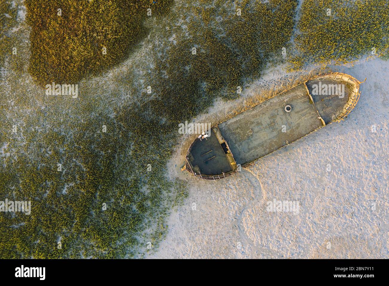 top view of a ship wrecked in a dry sea without water due to global ...