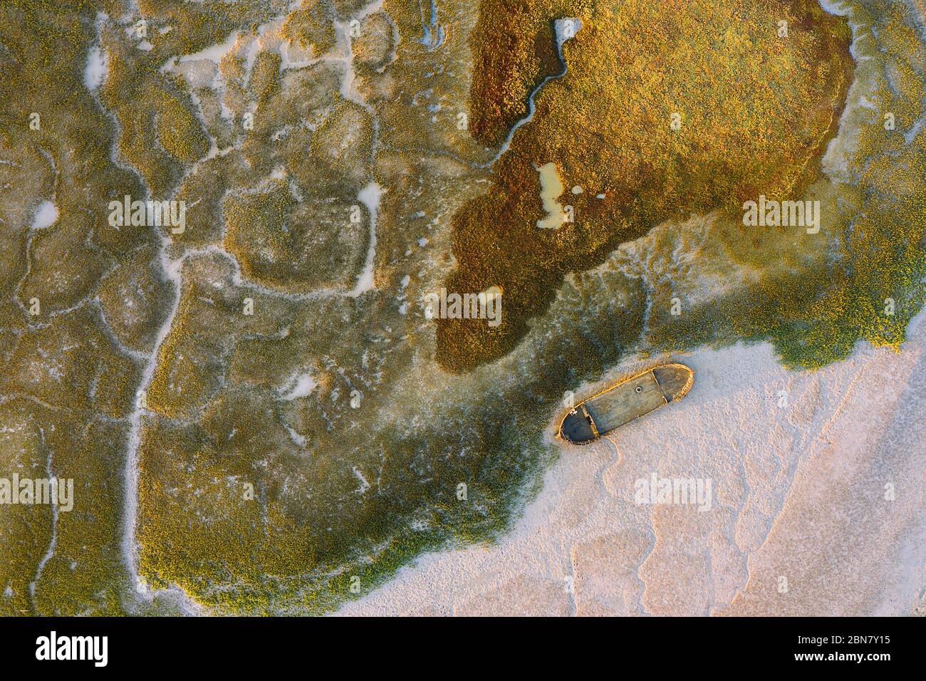 aerial view of a ship wrecked in a dry sea without water due to global ...