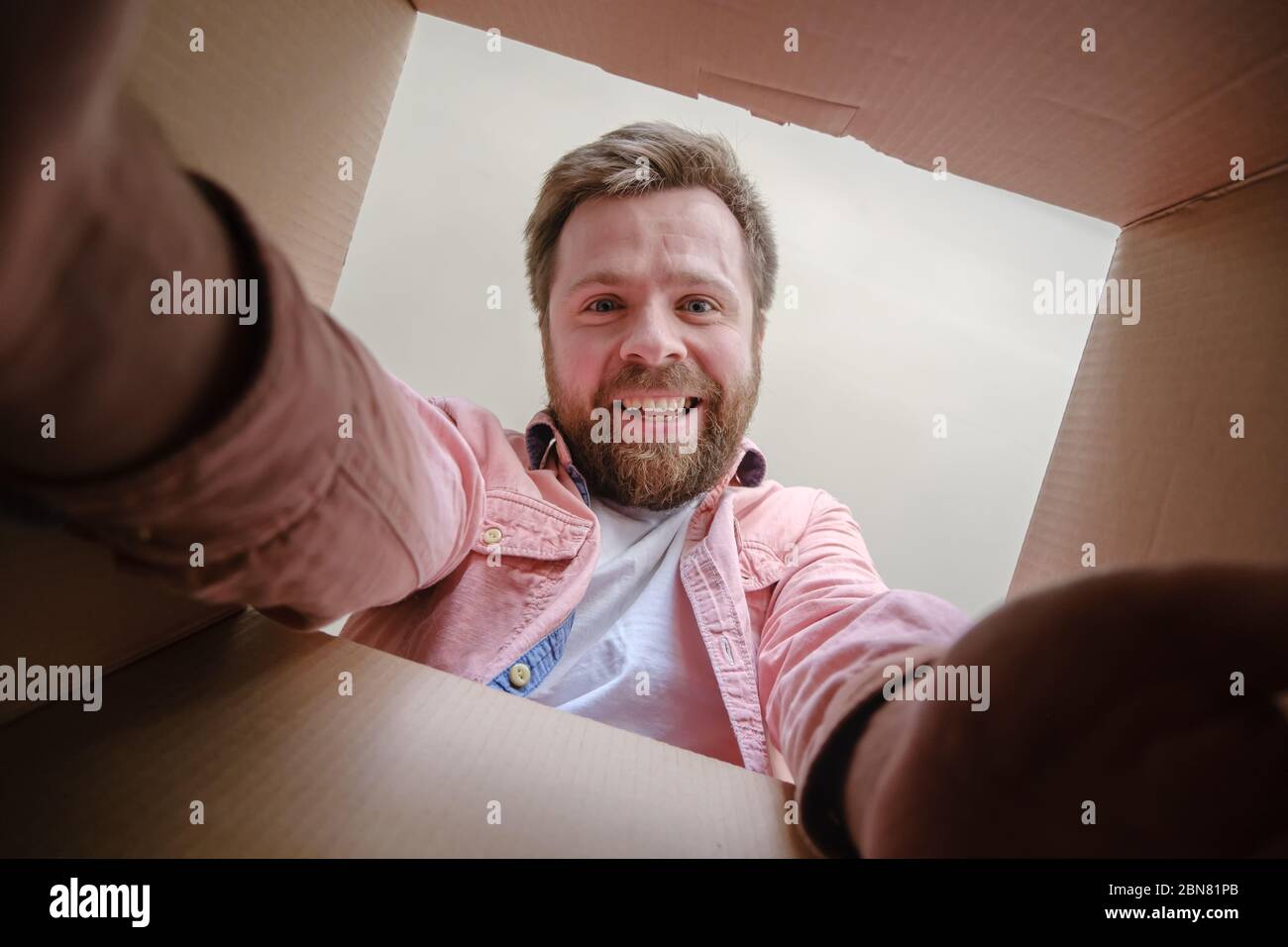 Man reaching into box hi-res stock photography and images - Alamy
