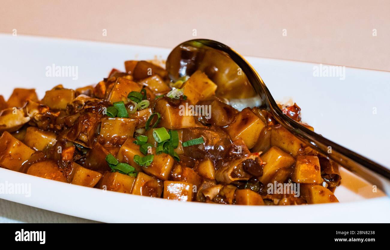 A dish of braised crab with glutinous rice cake served at the Shang ...