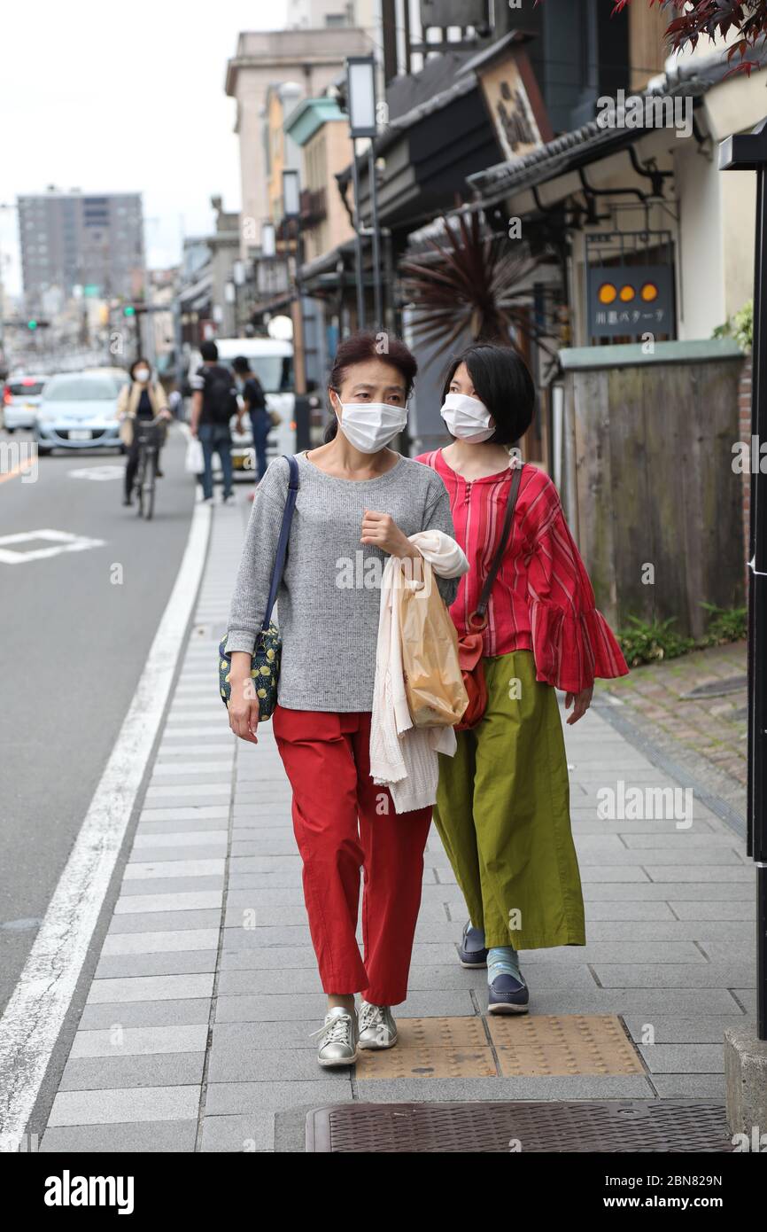 Japanese women walking in down town while wearing face masks as a ...