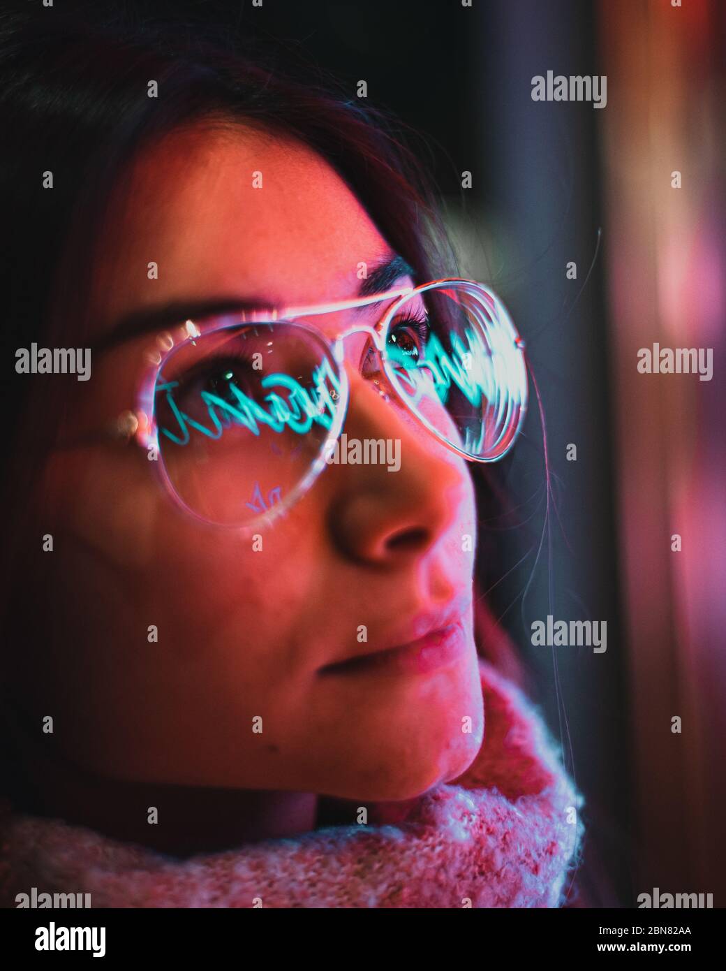 Neon light reflected on girl's glasses Stock Photo - Alamy
