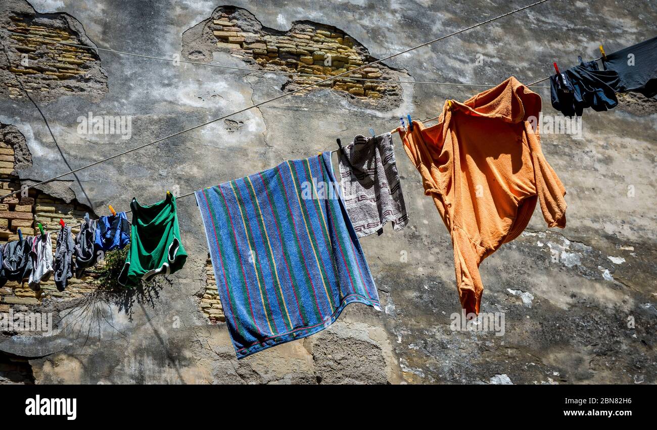 Colourful washing hanging out to dry between buildings in Corfu, Greece ...