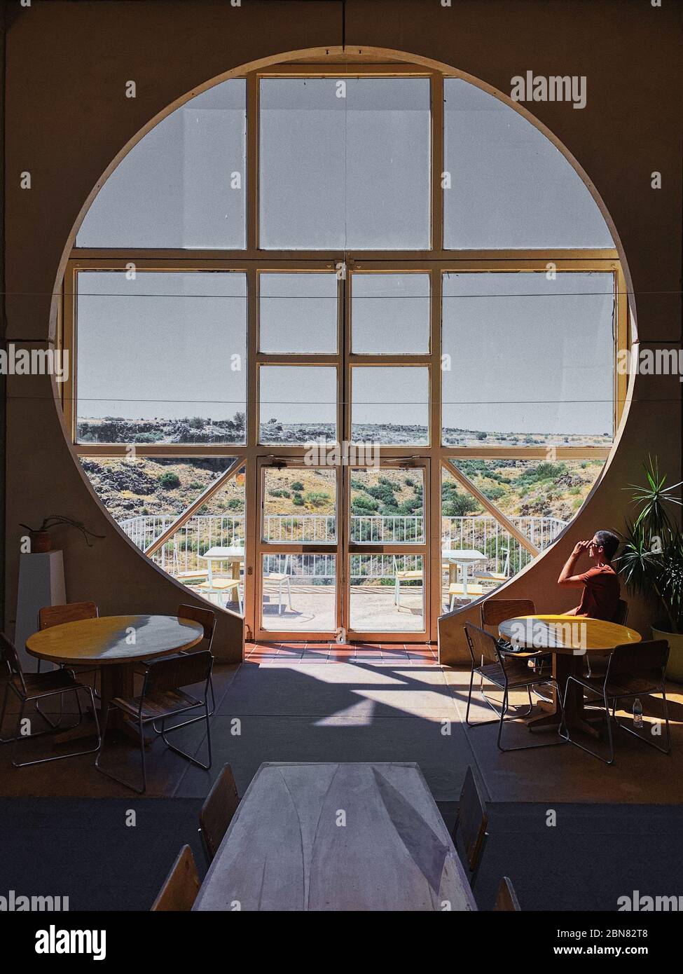 Perfect vertical shot of a round arch with windows overlooking outside ...