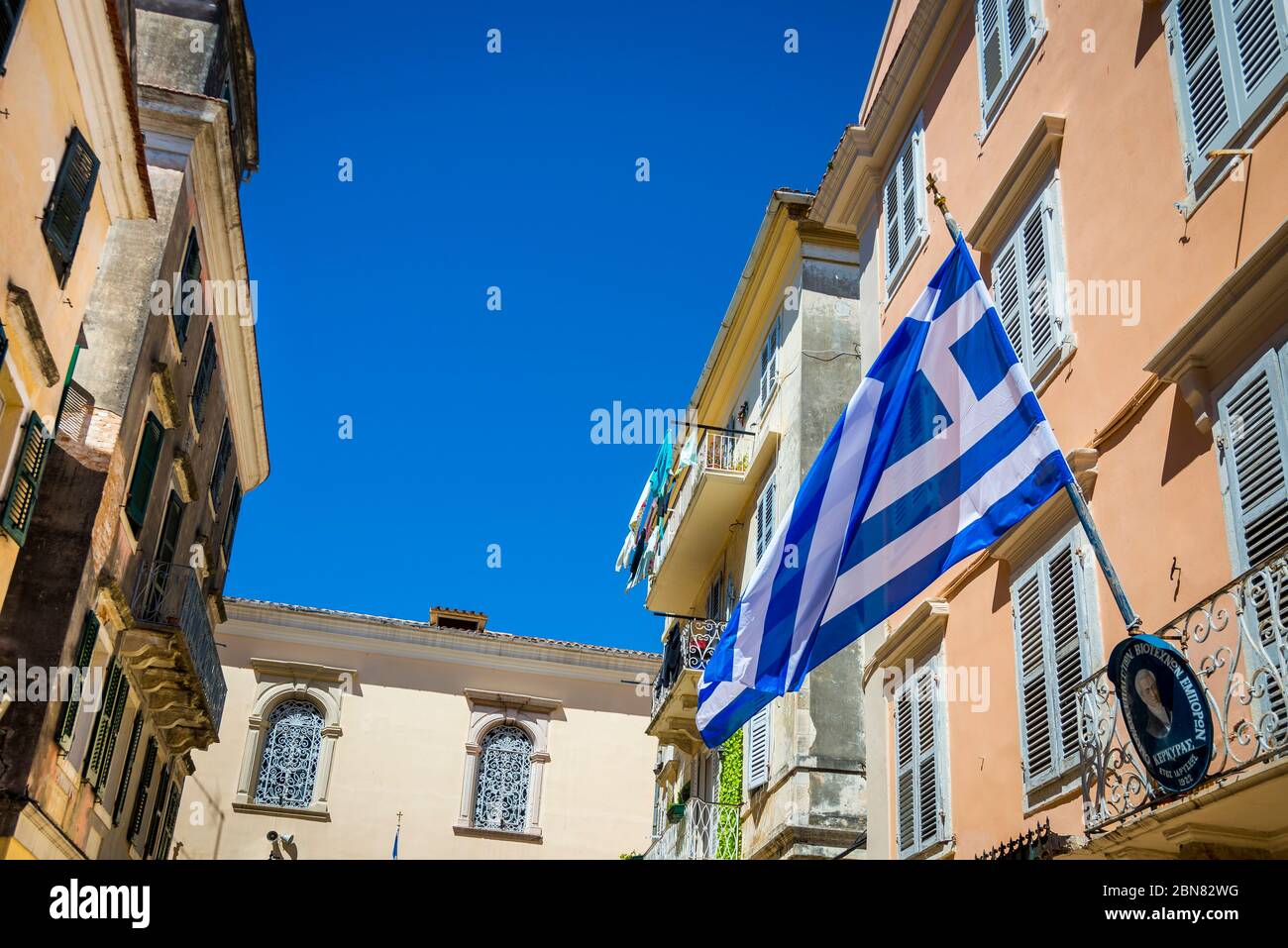 Greek flag flying from a balcony in Old Town Corfu, Greece Stock Photo ...