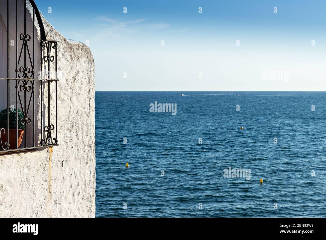 Window with pots and wrought iron fence overlooking the sea Stock Photo ...