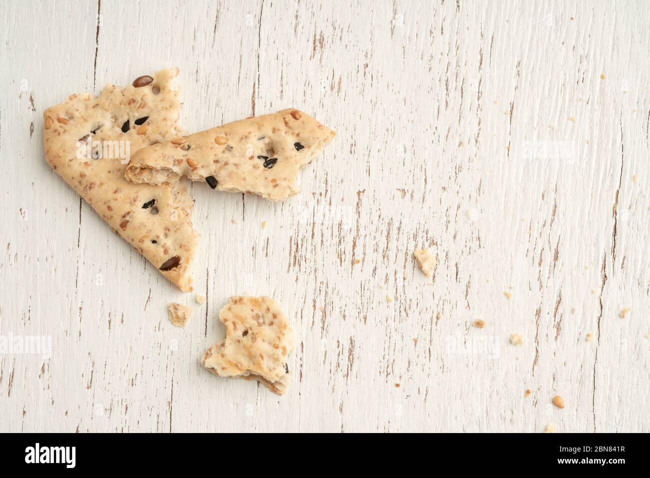leftover crumbs of biscuits on wooden table Stock Photo - Alamy