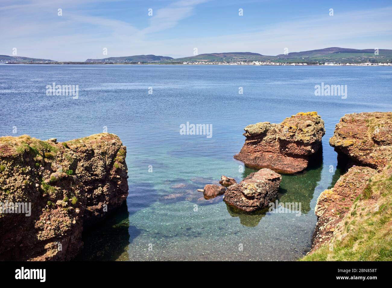 Rocks on Langness Peninsular with view across Castletown Bay Stock ...