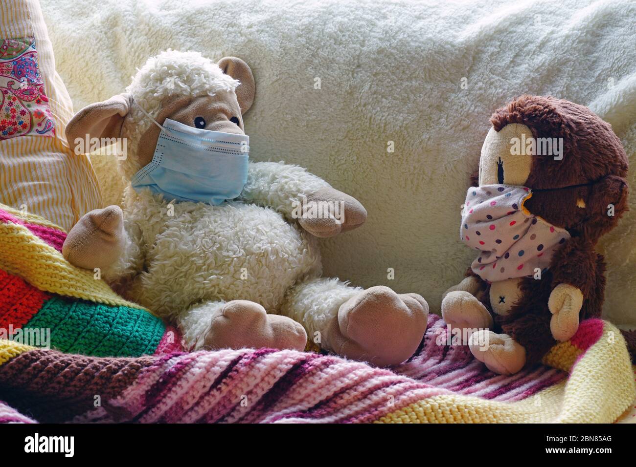 Two childrens plush stuffed animal toys earing a face mask during the ...