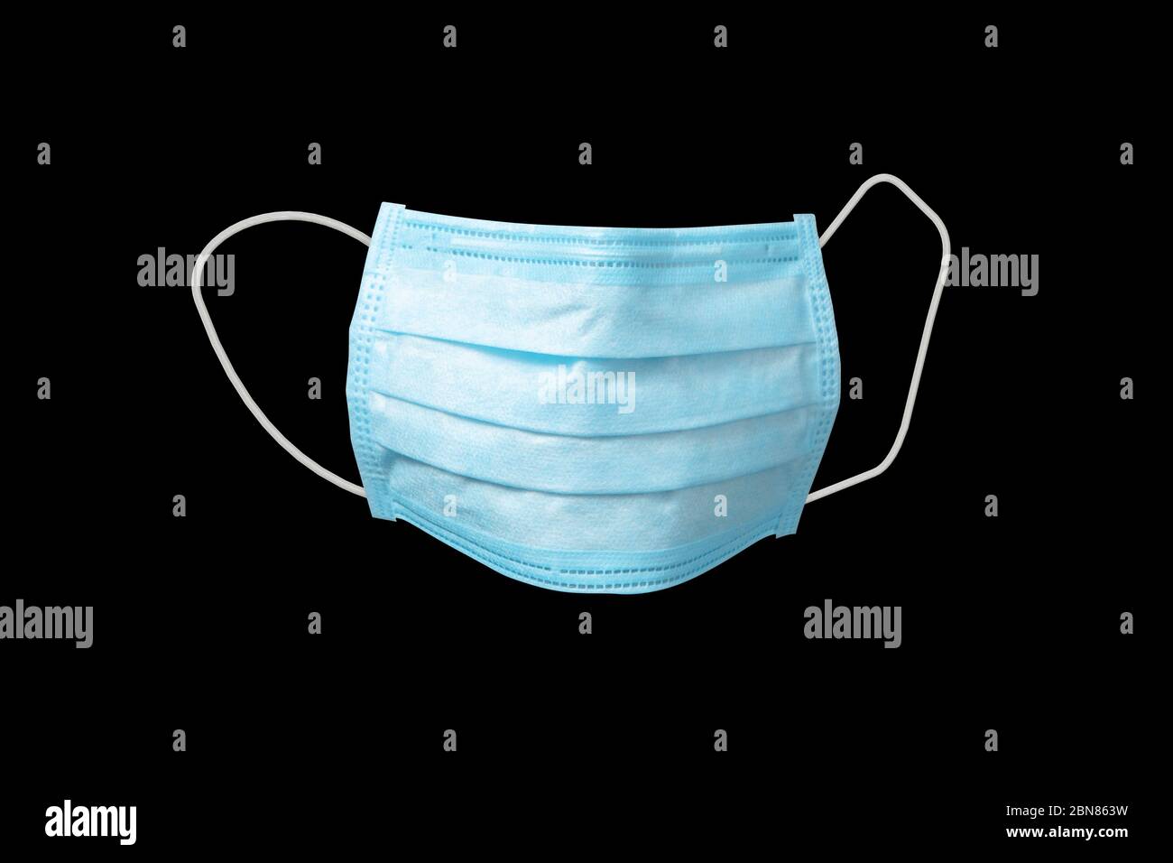 Medical antibacterial protective blue face mask on a black background ...