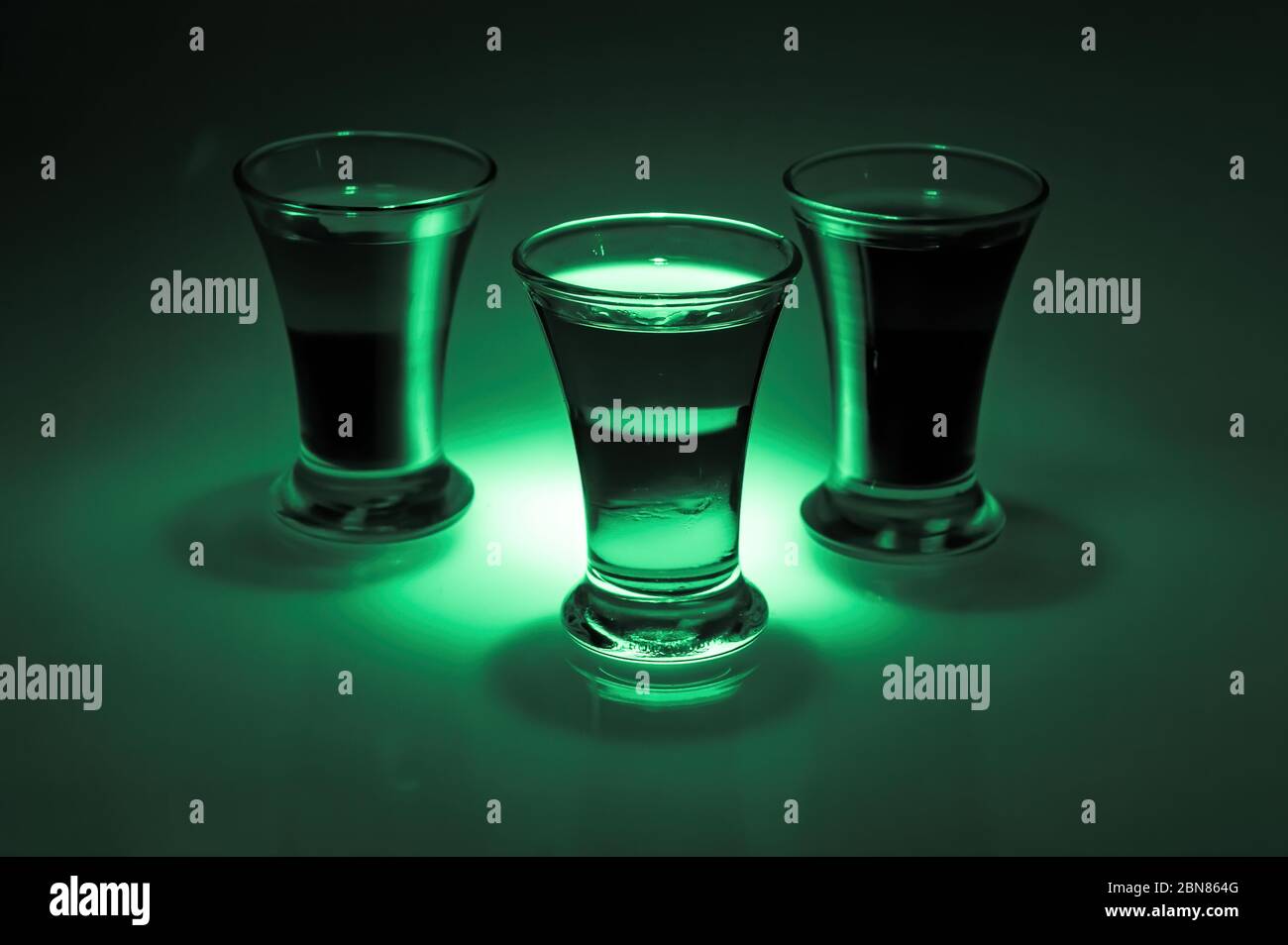 Three small shot glasses of alcoholic beverages Stock Photo - Alamy