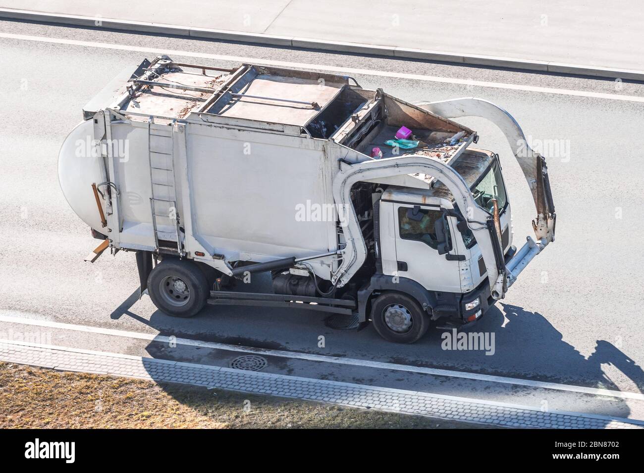 Garbage truck for the transportation of waste goes on city road Stock ...