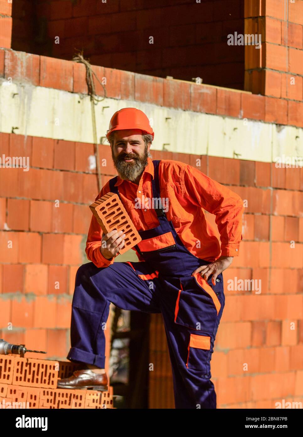 build your own future. happy bearded man hold brick. brickwork. Man ...