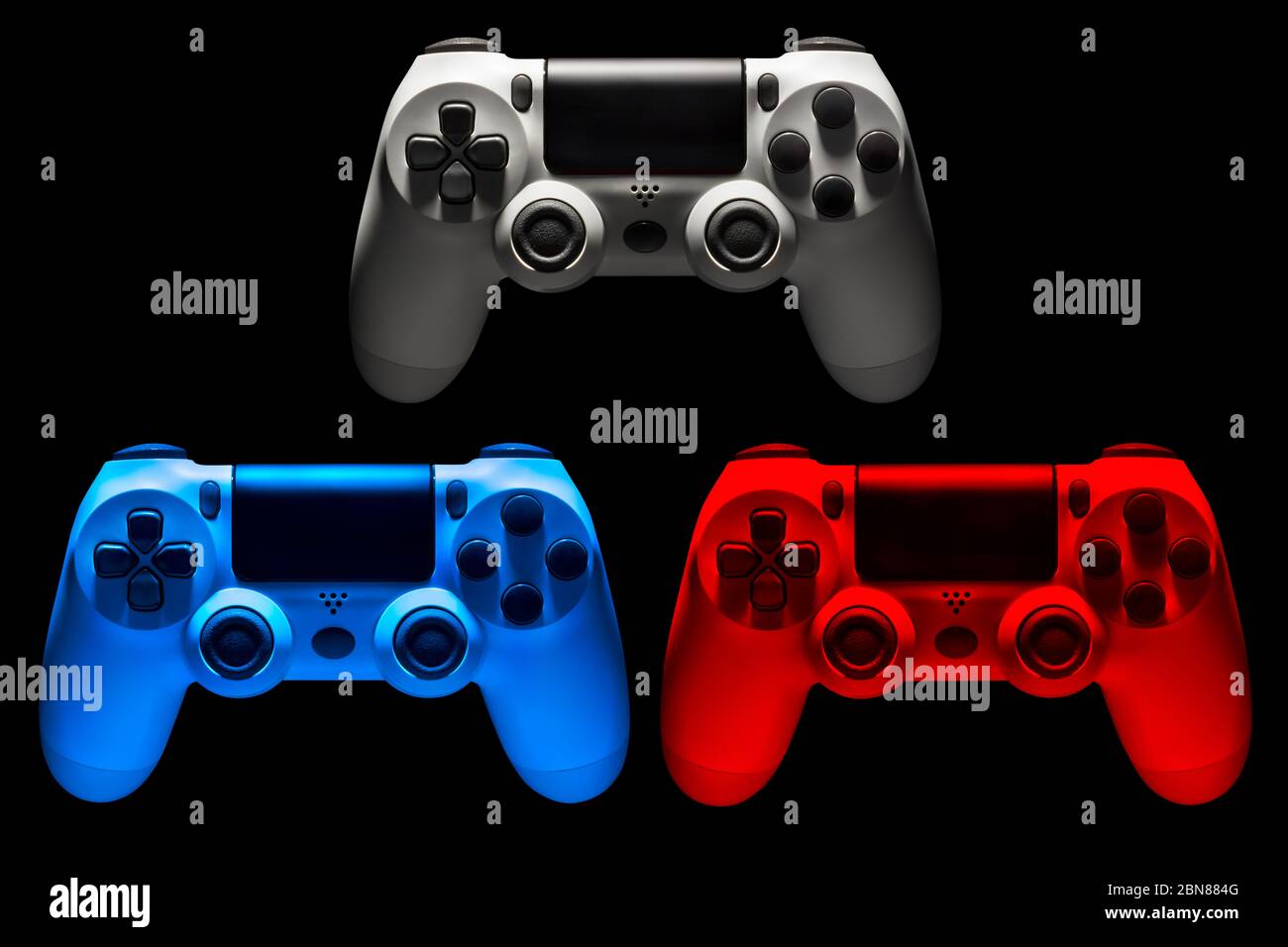 Set of colorful video game joysticks gamepad isolated on a black ...