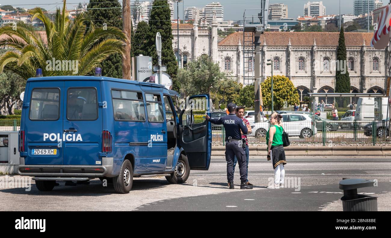 Lisbon, Portugal - May 7, 2018: Policeman chatting with passers-by next ...