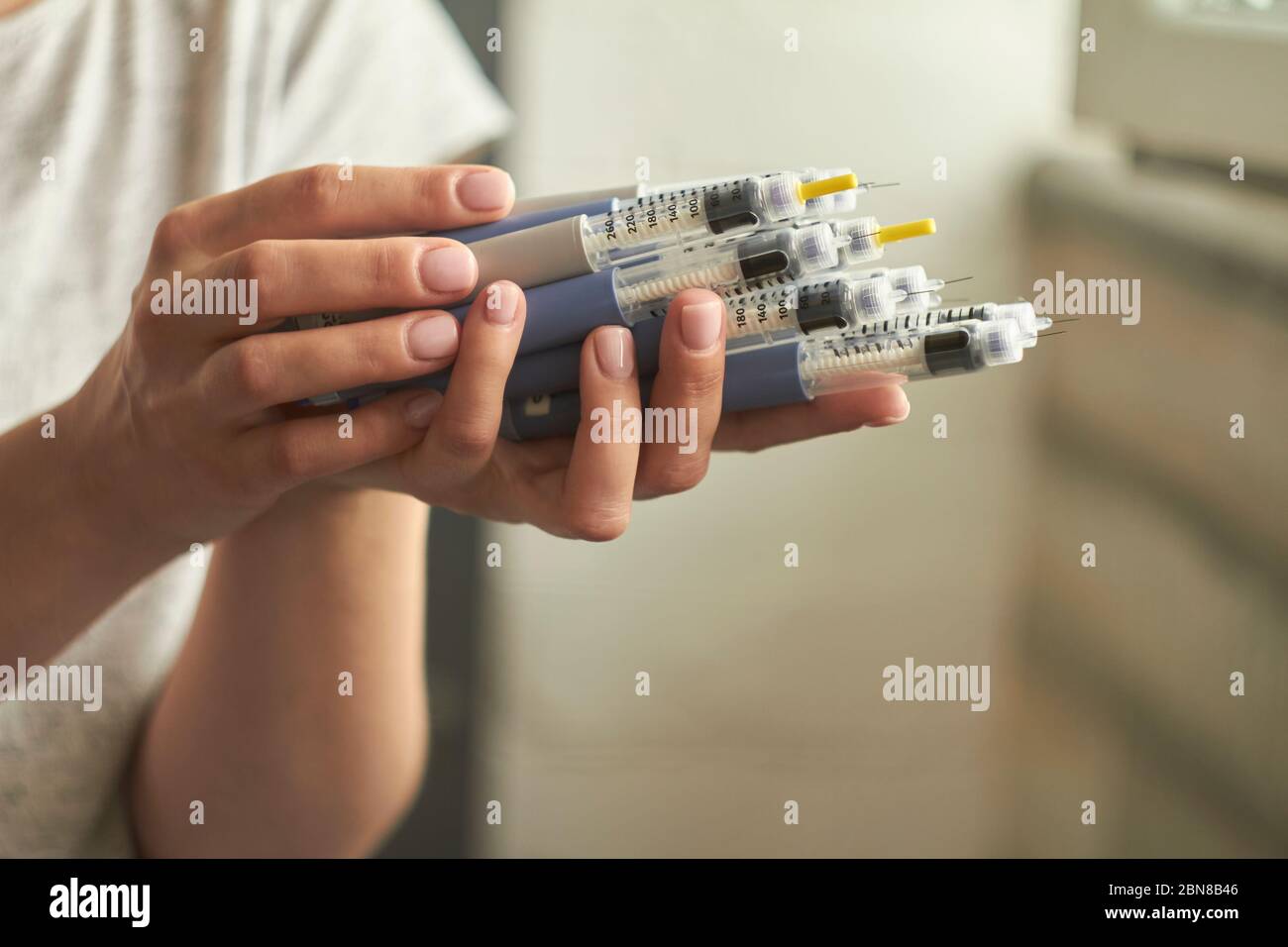Diabetes insulin dependent concept, hands with syringes pen injectors ...