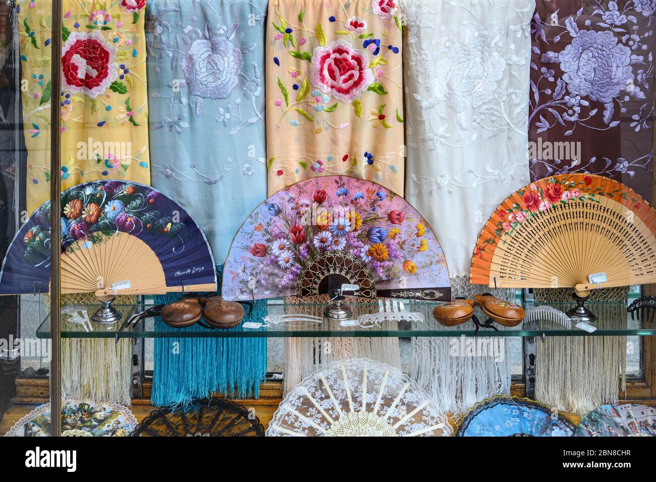 Traditional Spanish fans and embroidered shawls on sale in the shop ...