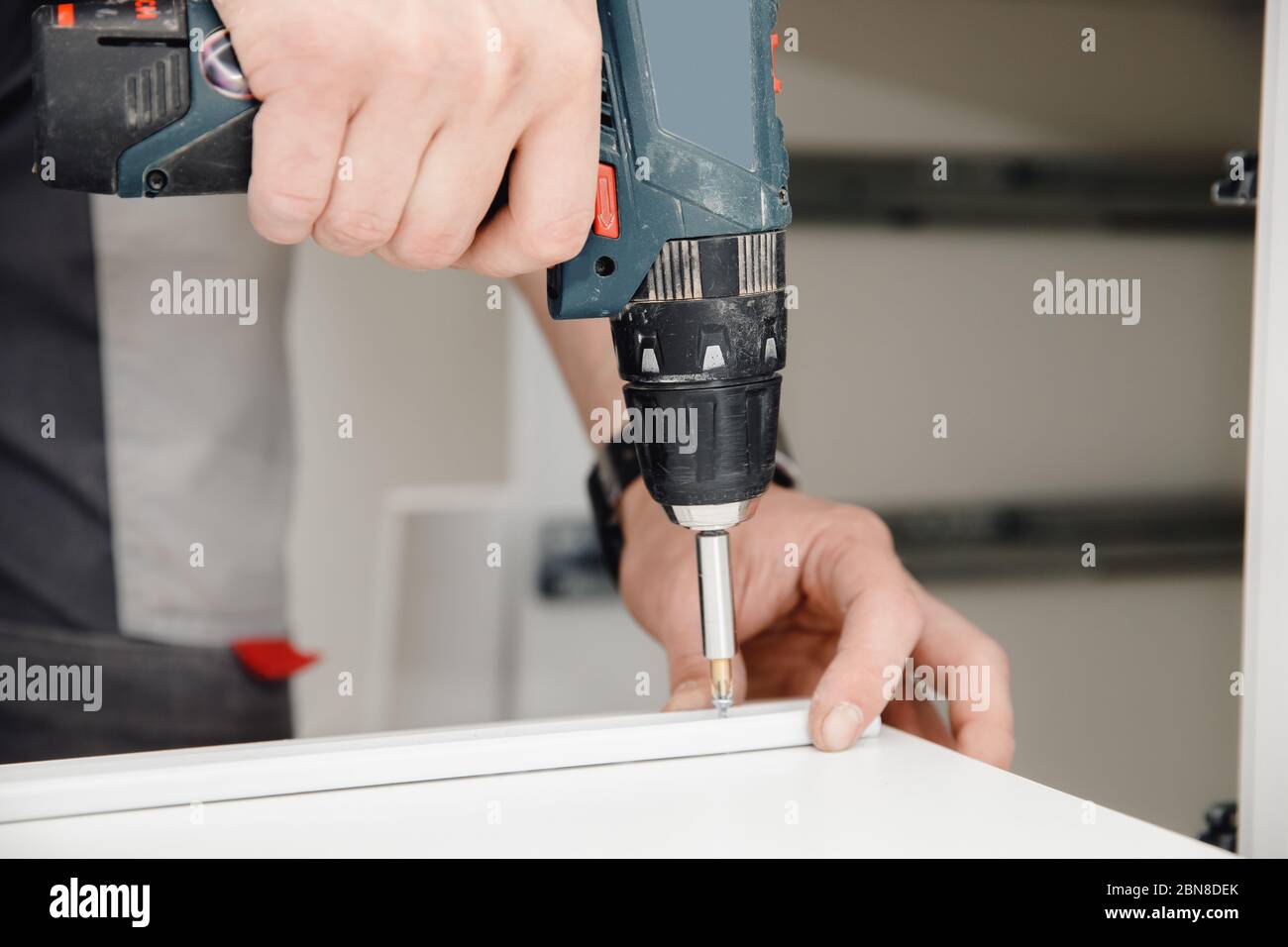 Kitchen installation, worker furniture assembly with tools Stock Photo ...