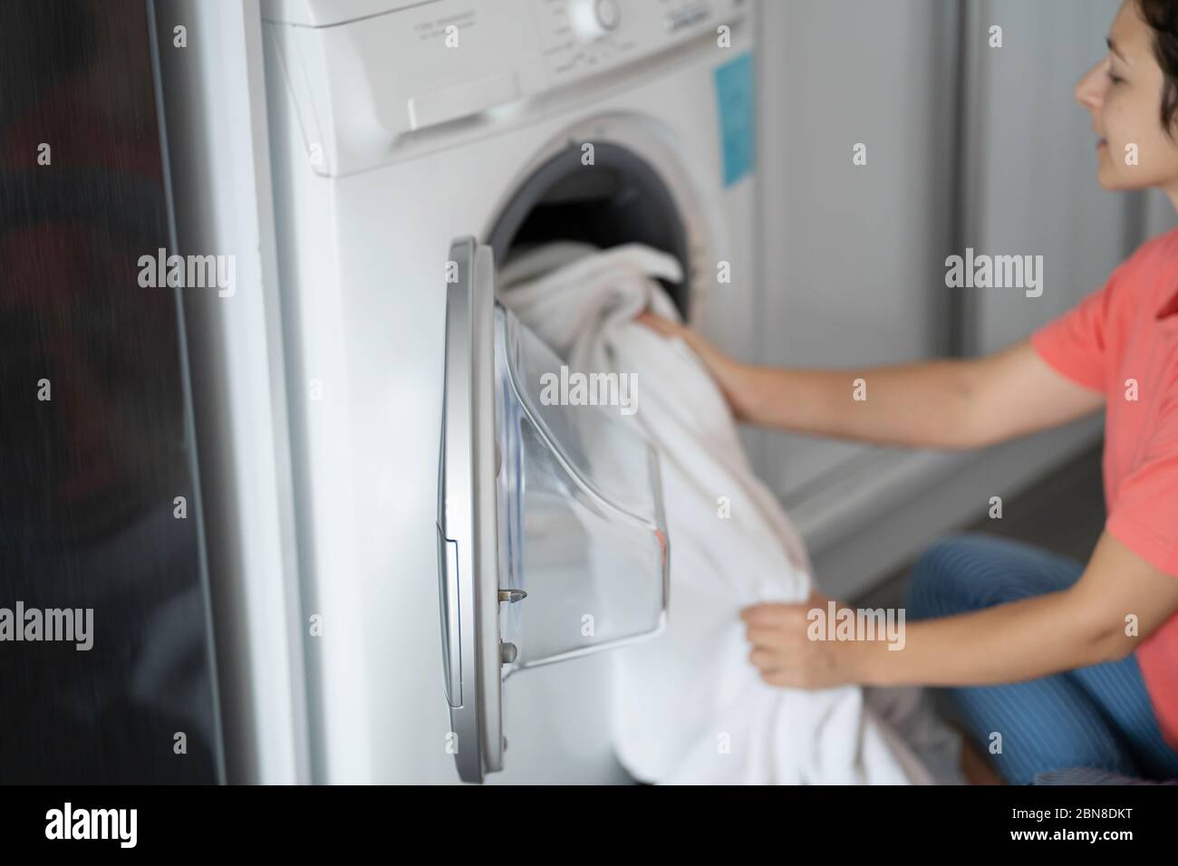 Girl sitting on washing machine hi-res stock photography and images - Alamy